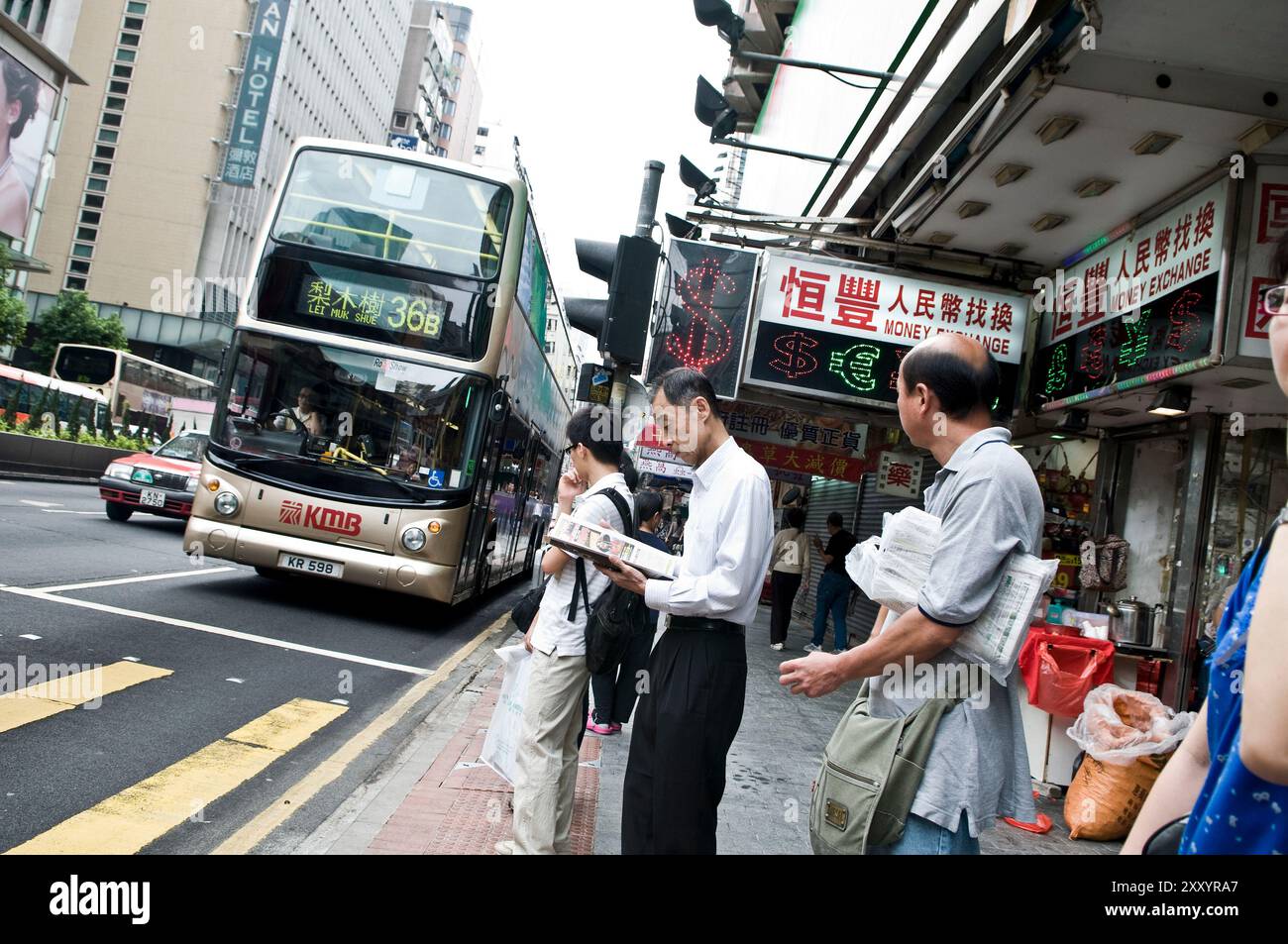 Passengers waiting for the bus on Nathan road in Yau ma tei, Kowloon ...