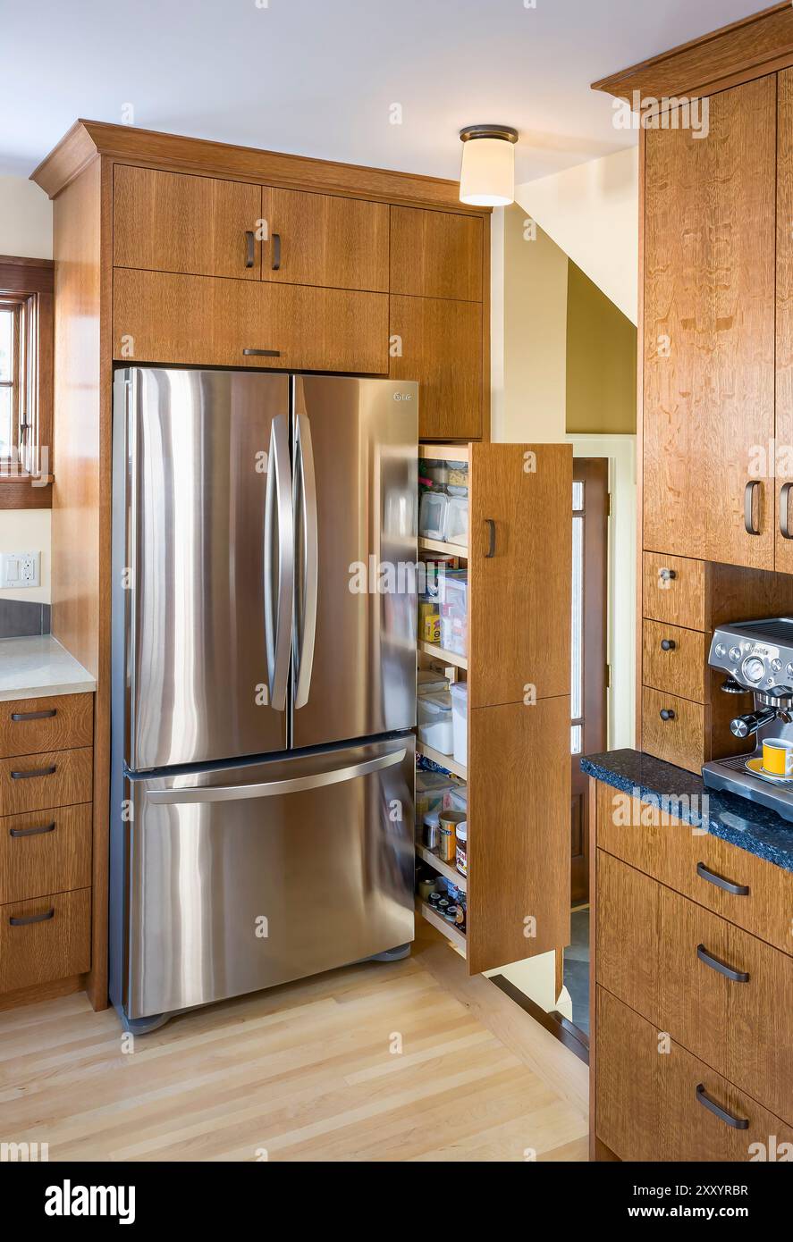 Large vertical pull-out pantry drawer next to refrigerator open Stock ...