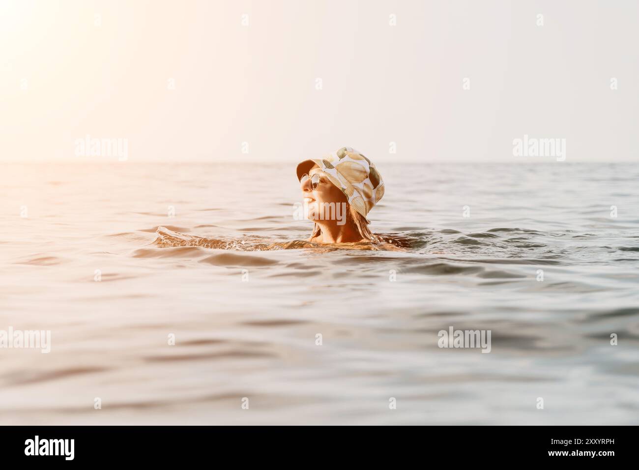 Woman Swimming Sea Ocean - A woman in a white and black bathing cap ...