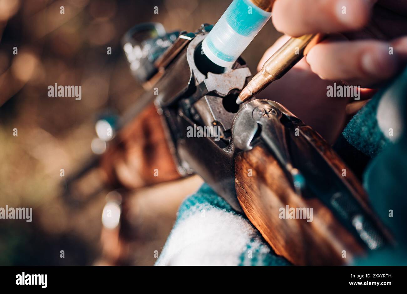 Man is charging a hunting rifle. American hunting rifles. Hunter with ...