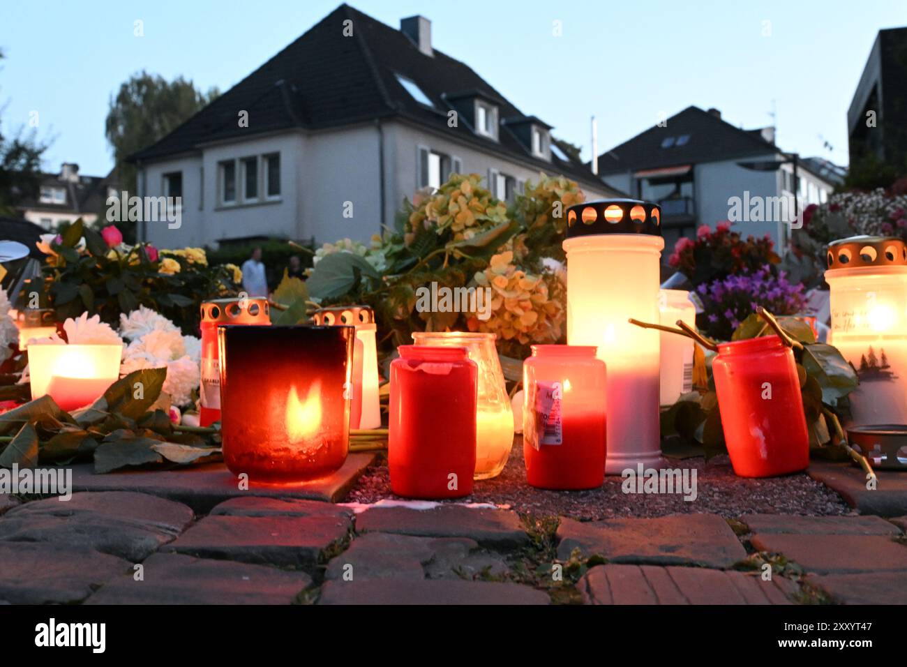 27 August 2024, North Rhine-Westphalia, Solingen: Candles and flowers ...