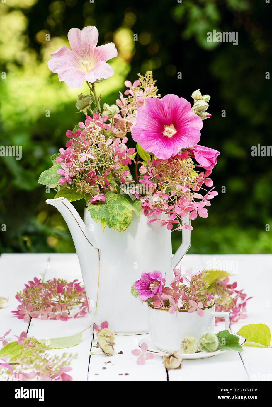 Flower arrangement with pink, magenta hollyhock and purple hydrangea ...