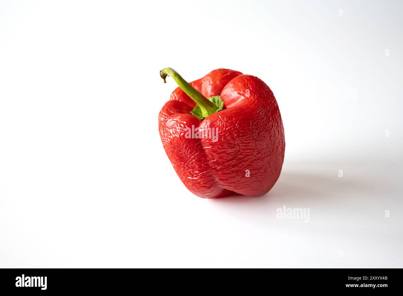 Red, spoiled, wrinkled or overripe bell pepper against white background ...