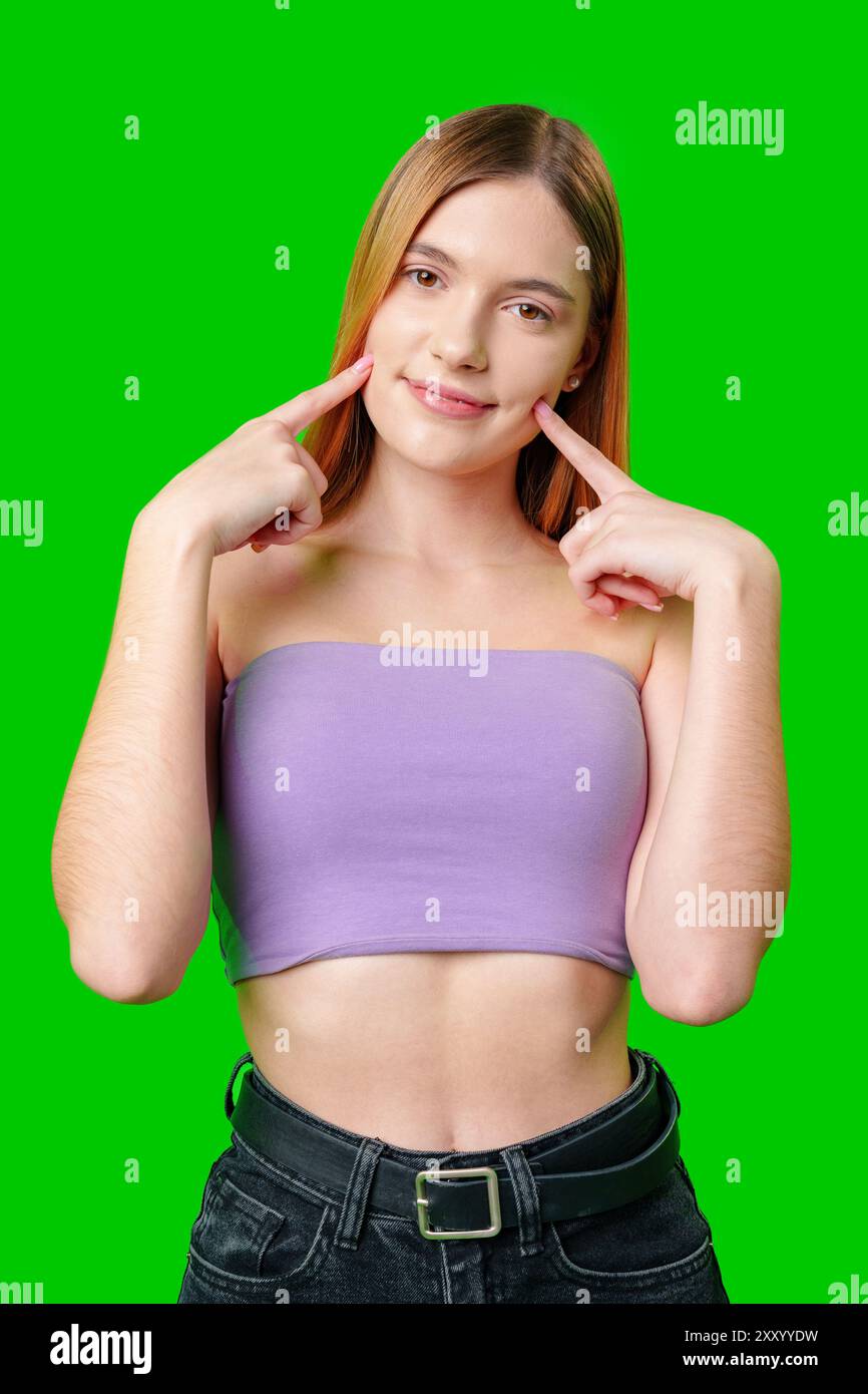 Young Woman Smiling and Touching Cheeks in Front of Green Screen Stock ...