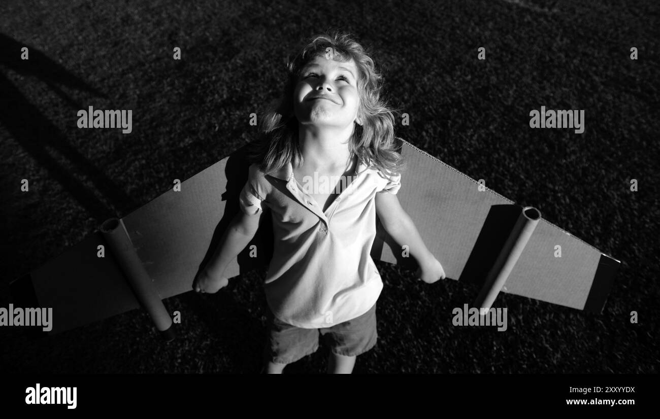 Child boy playing with toy airplane wings. Dream of becoming a pilot ...