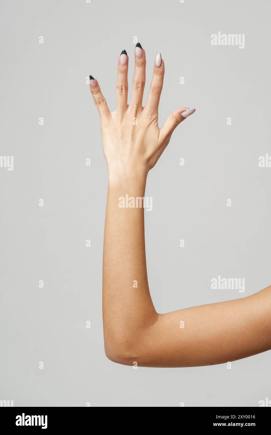 Woman's Arm Extended With Hand Open and Fingers Against a White ...