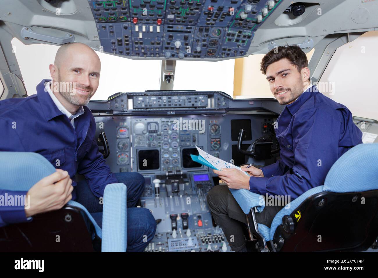 two pilots operate a switches of aircraft system Stock Photo - Alamy