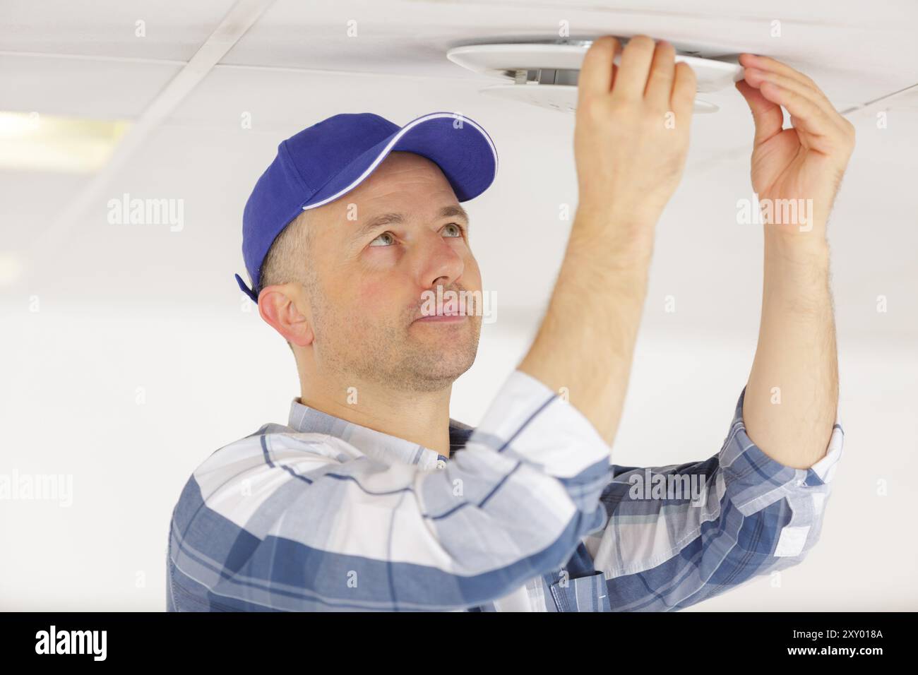 a mature man replacing the light bulb at home Stock Photo - Alamy