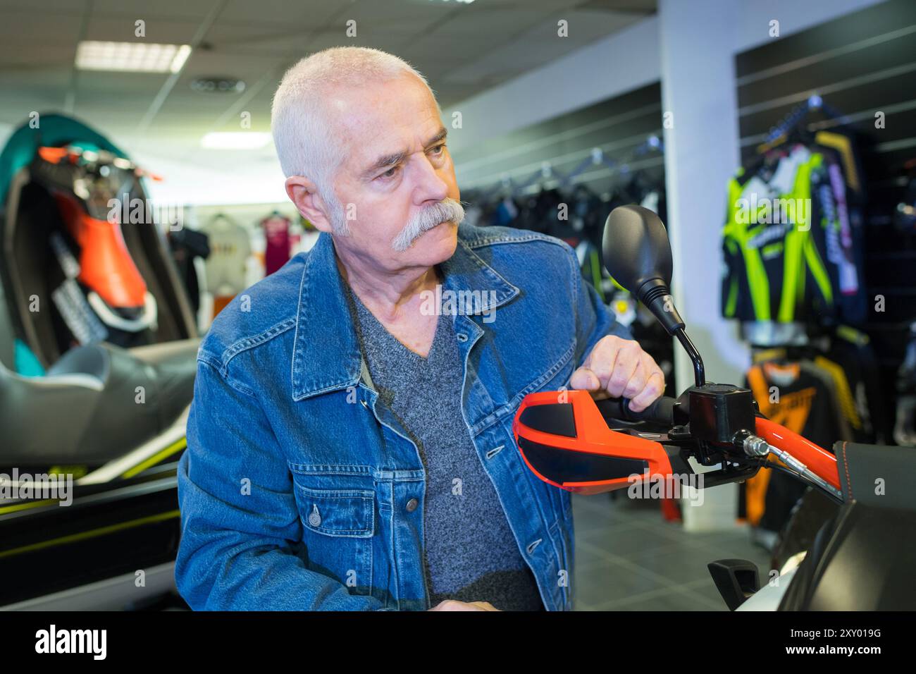 senior man in motorsport showroom Stock Photo - Alamy