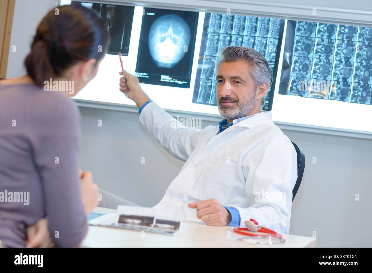 doctor showing mri scan results to female patient Stock Photo - Alamy