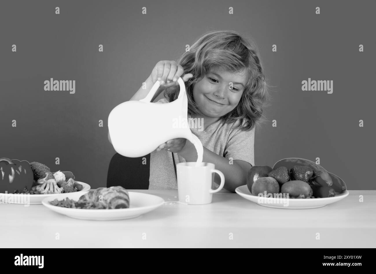 Child drink dairy milk. Kid pours dairy milk Stock Photo - Alamy