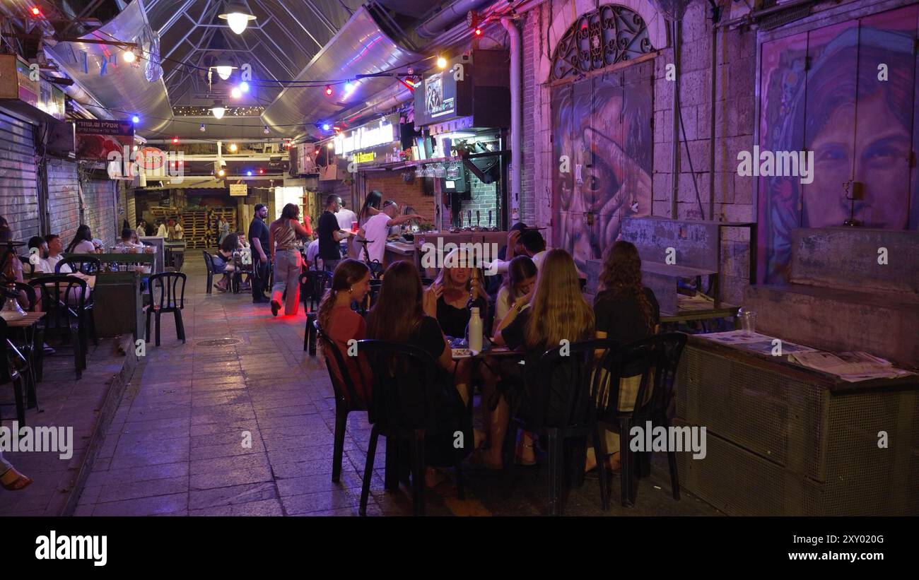 People sit in a bar in the Mahane or Machane Yehuda market often ...