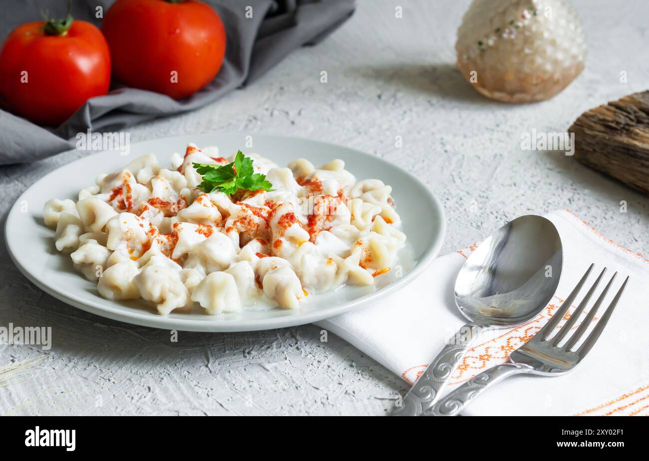 Turkish traditional food ravioli with yoghurt and tomato sauce in plate ...
