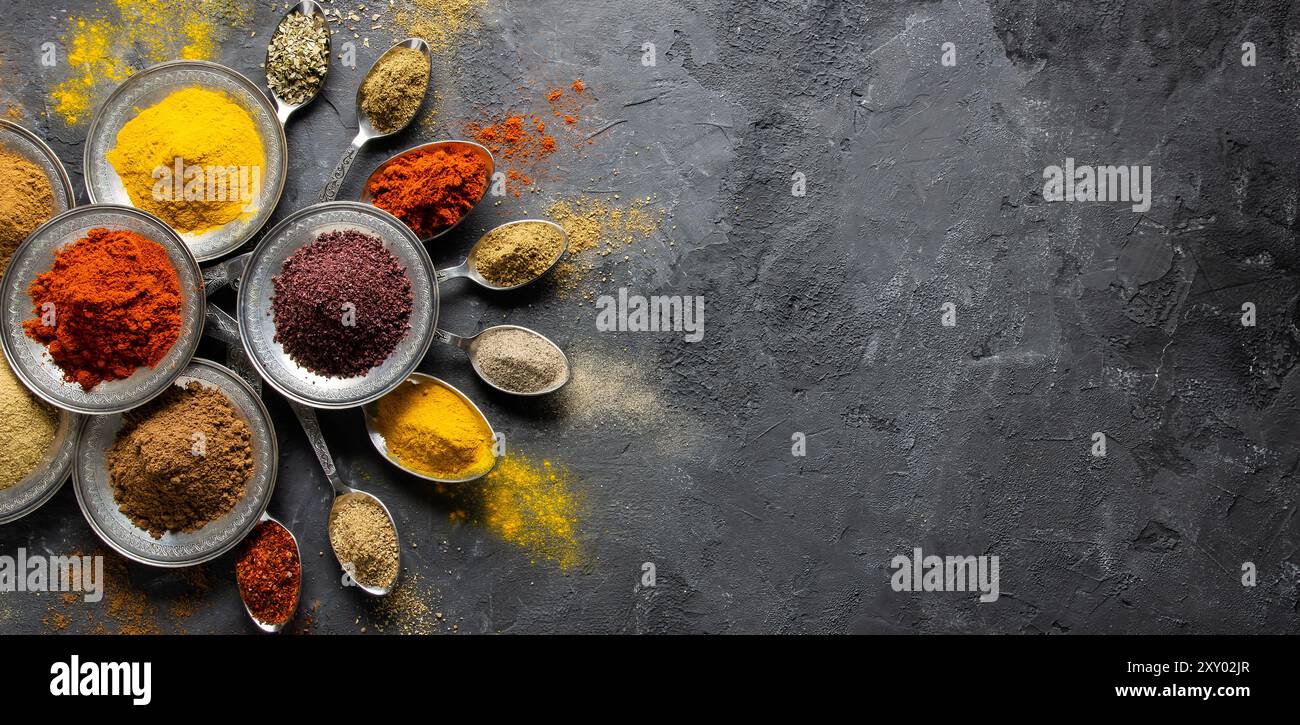 Assortment of natural spices on a vintage silver spoons or dishes on ...