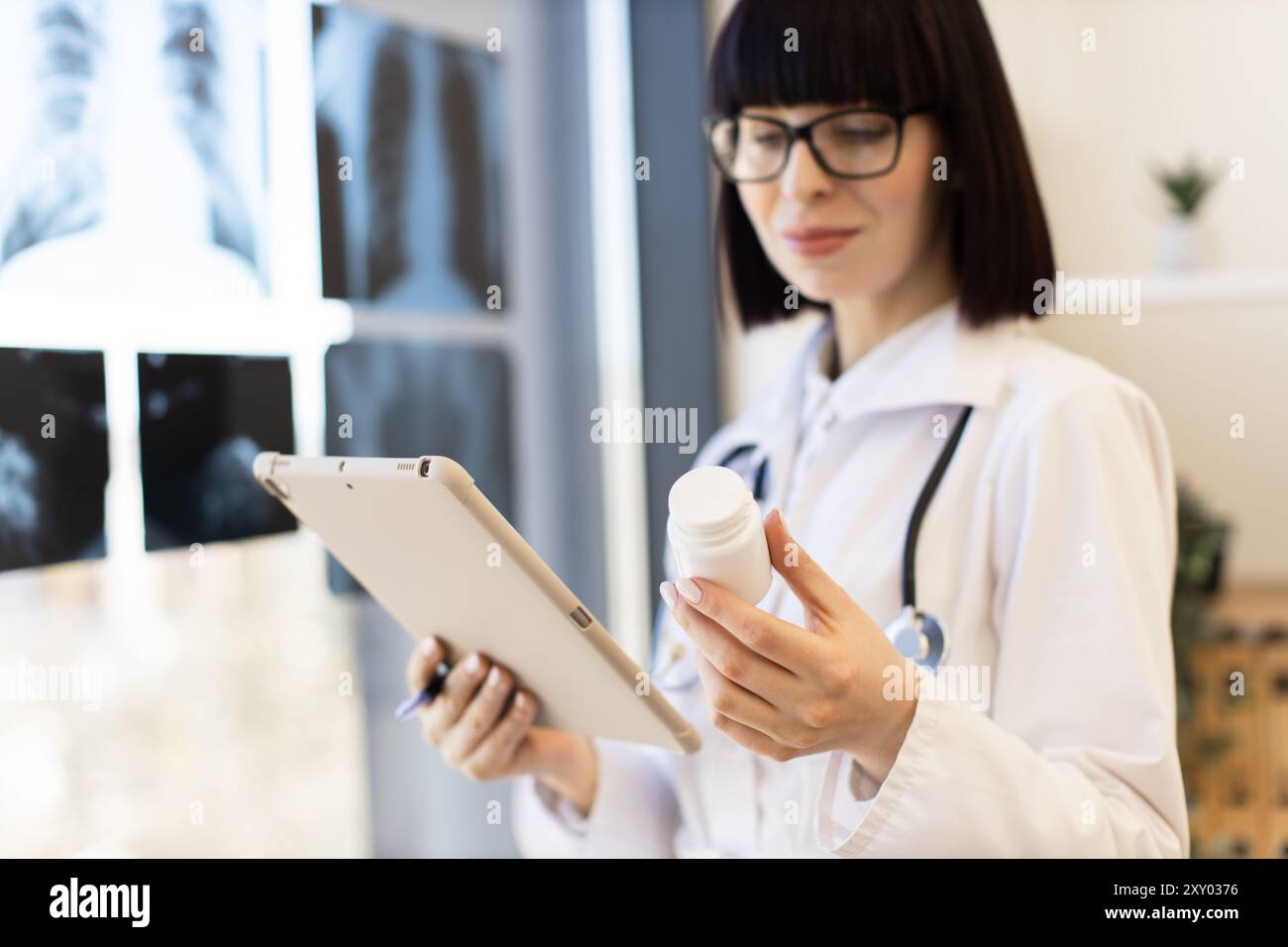 Doctor reviewing prescription medication with digital tablet Stock ...