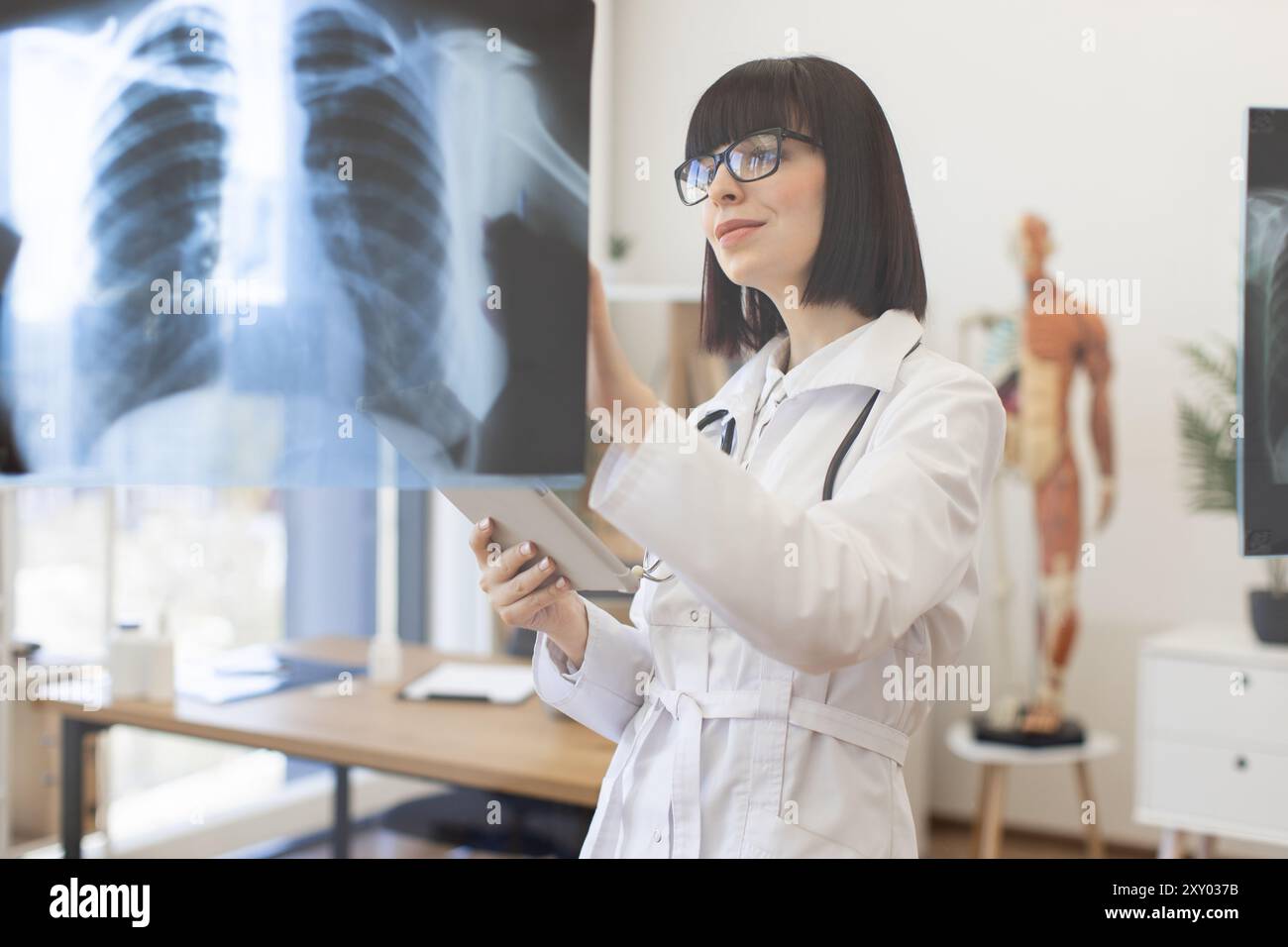 Female doctor examining chest x-rays in medical office Stock Photo - Alamy