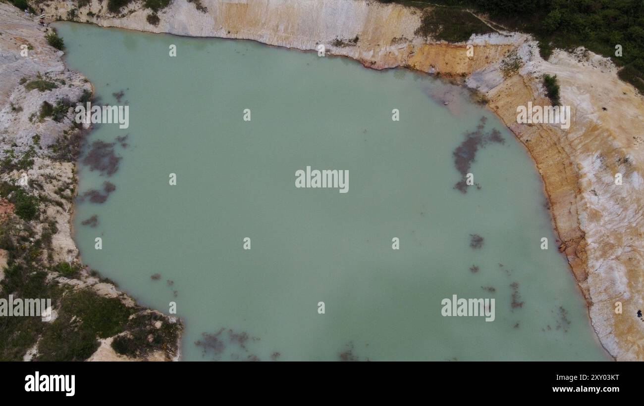 flooded quarry photographed from a drone. the water is with kaolin ...