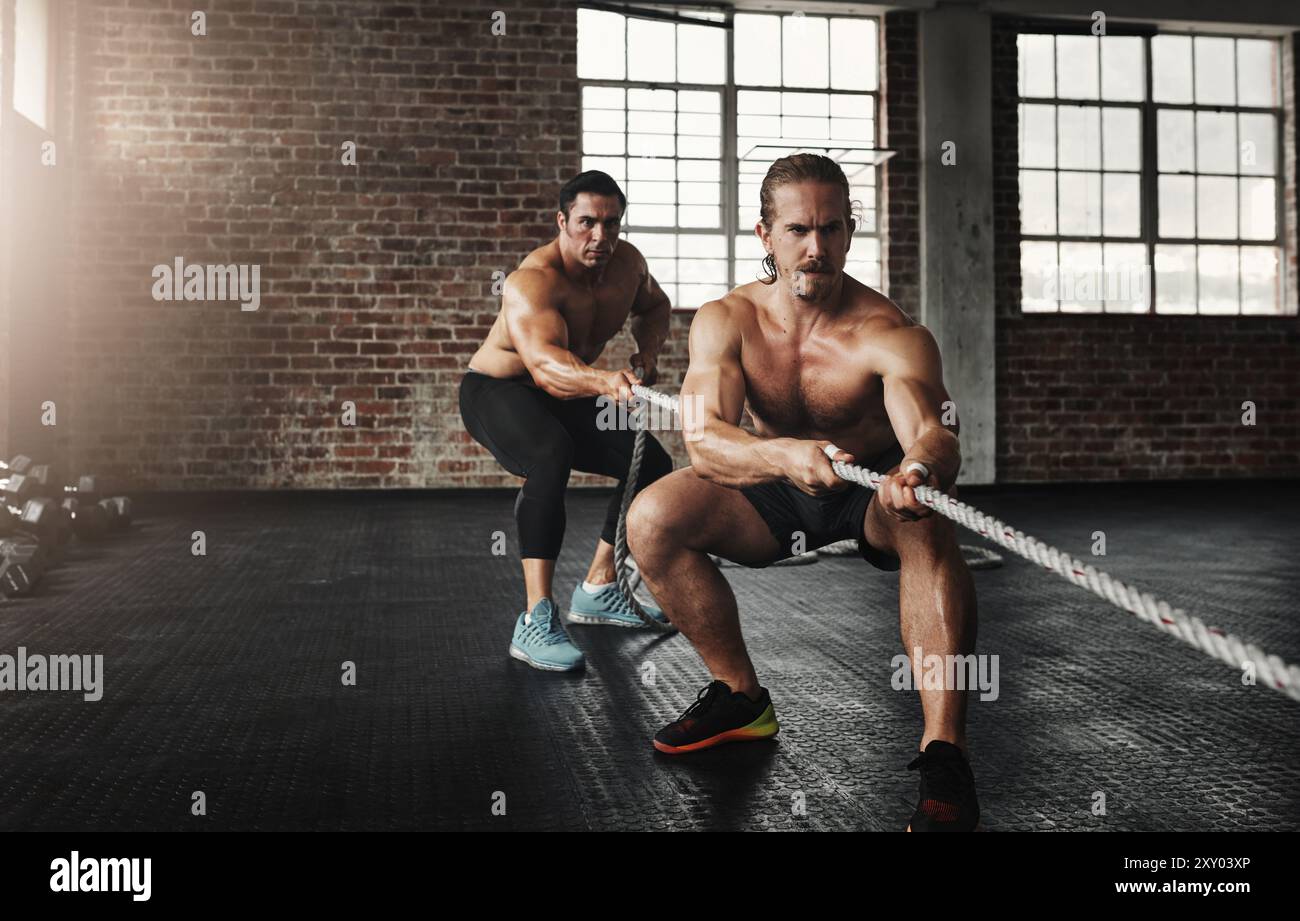 Man, pull and exercise in gym with rope for fitness, workout and muscle ...