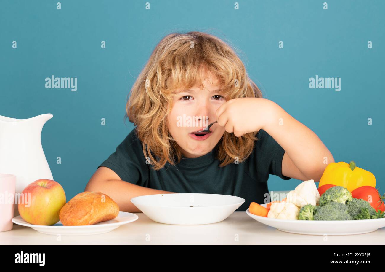 A cute little boy having soup for lunch. Child eating soup Stock Photo ...