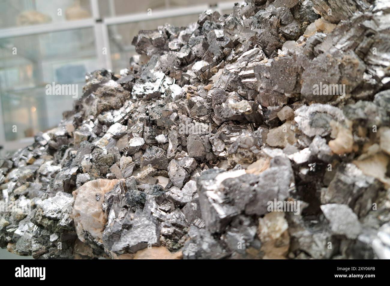 A close-up image of a metallic mineral specimen, featuring shiny ...