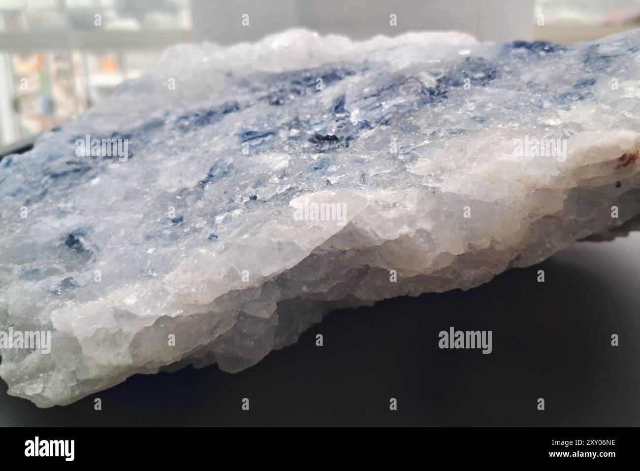 A close-up of a quartz mineral with blue inclusions, showcasing its ...