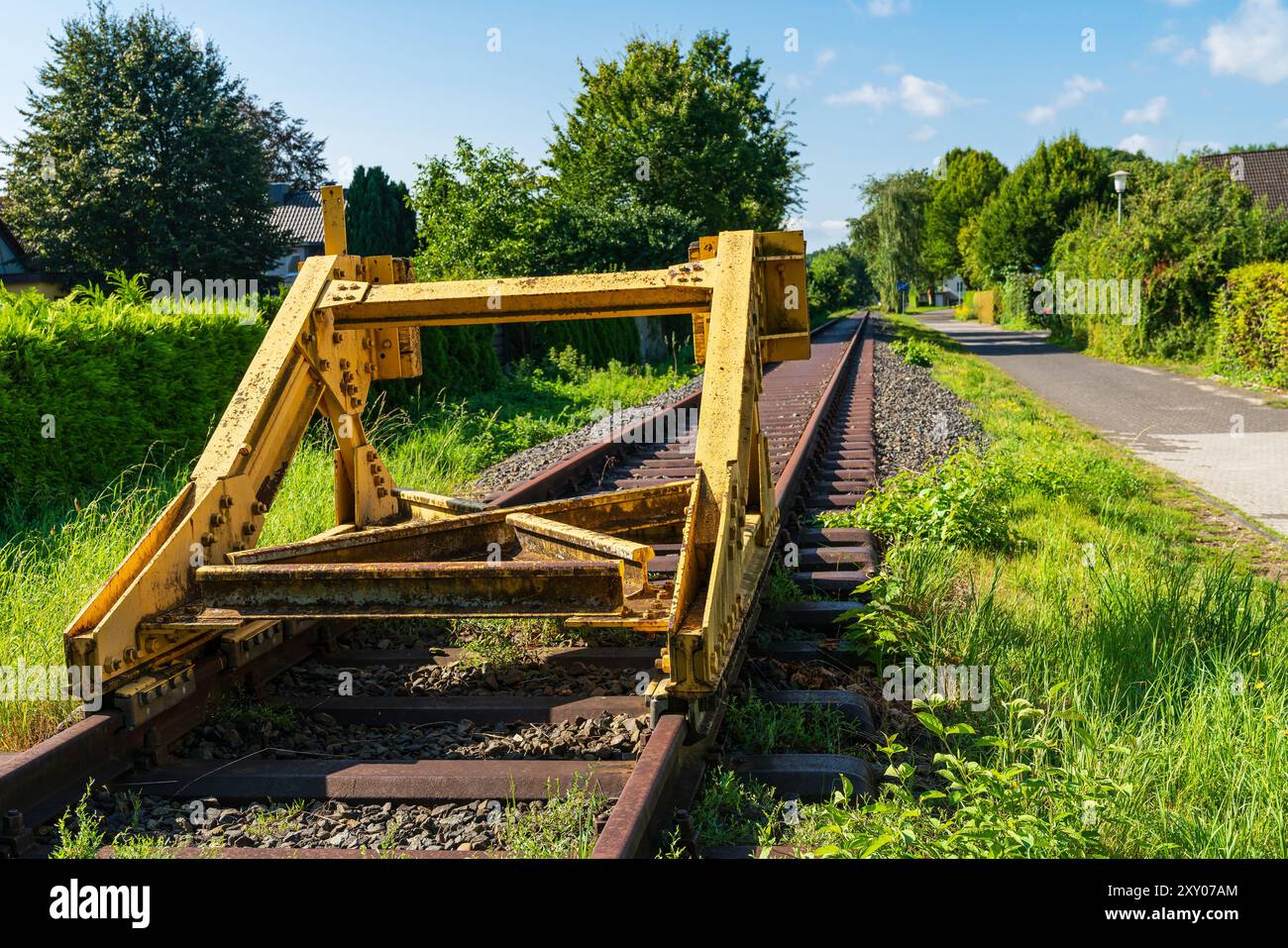 Old abandoned railway siding with metal yellow restriction. Dead-end ...