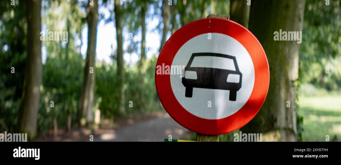 Prohibited entry for cars round traffic sign on the side of a road ...