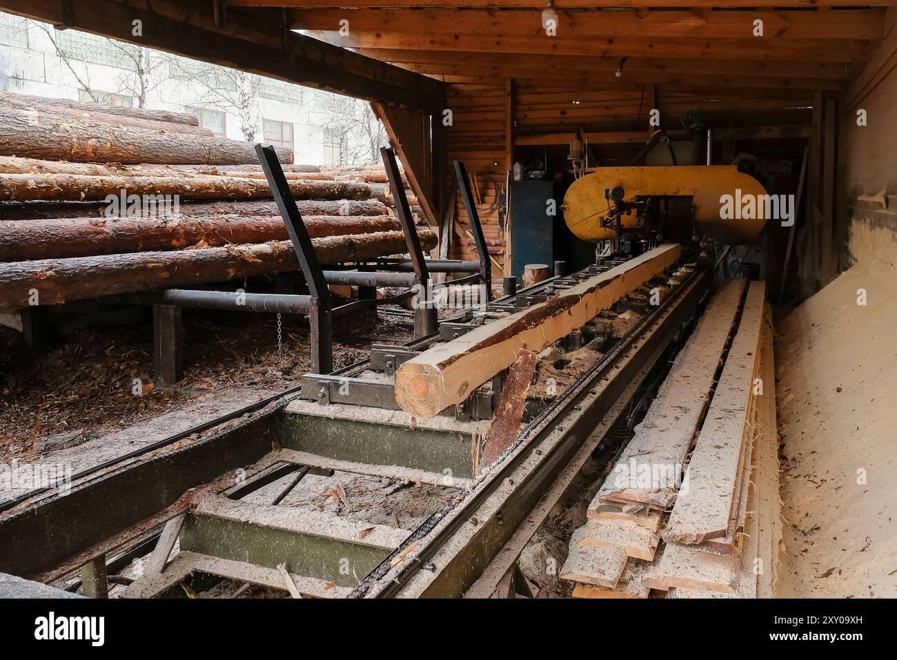 Industrial sawing of boards from logs on a sawmill. The process of ...