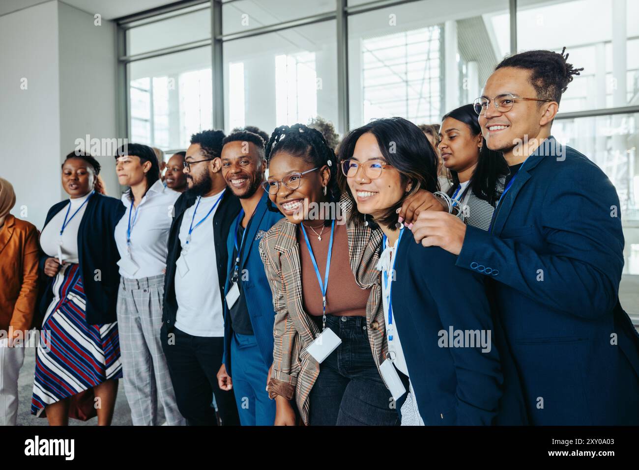 Group of diverse conference staff posing together for a photo ...
