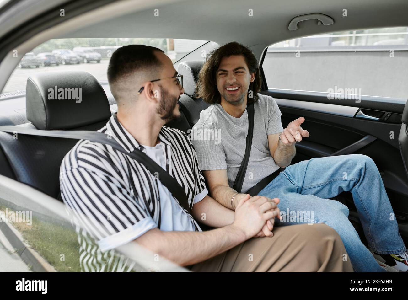 Two men laugh together in the backseat of a car Stock Photo - Alamy