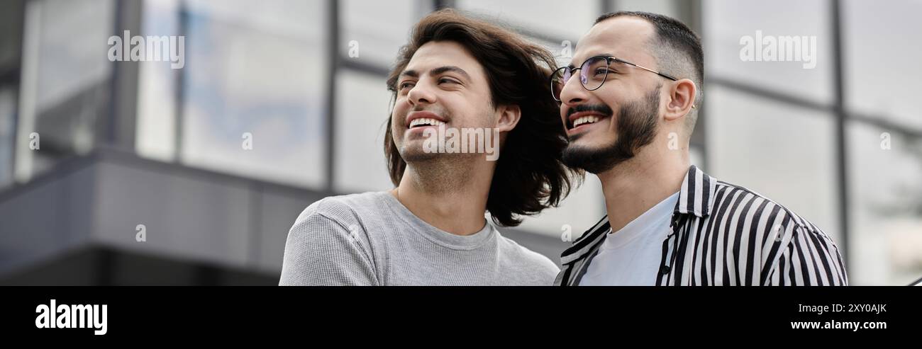 Two men walk side-by-side, laughing and looking happy Stock Photo - Alamy