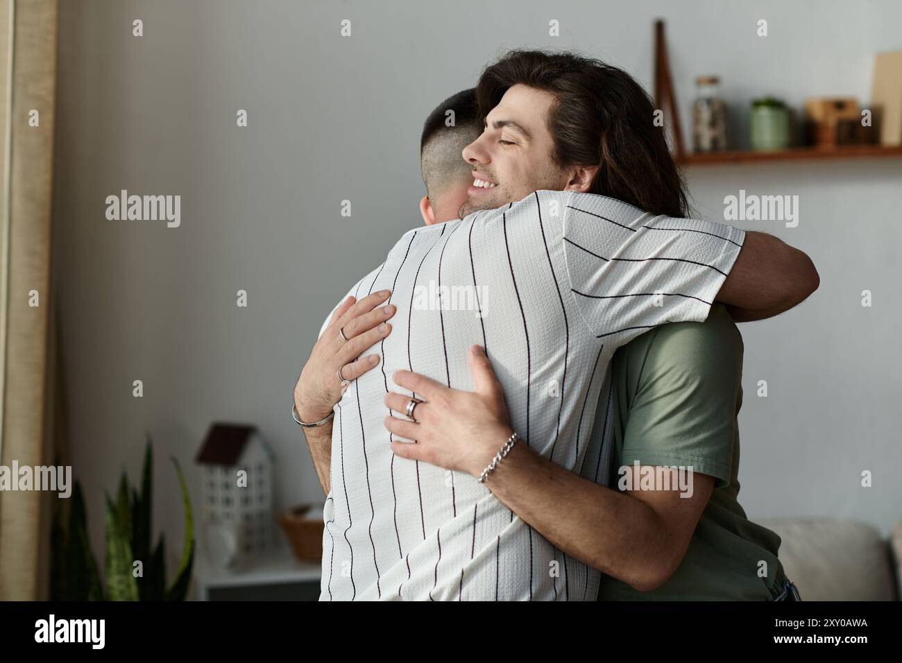 Two men hug tightly, expressing their love and affection for each other ...