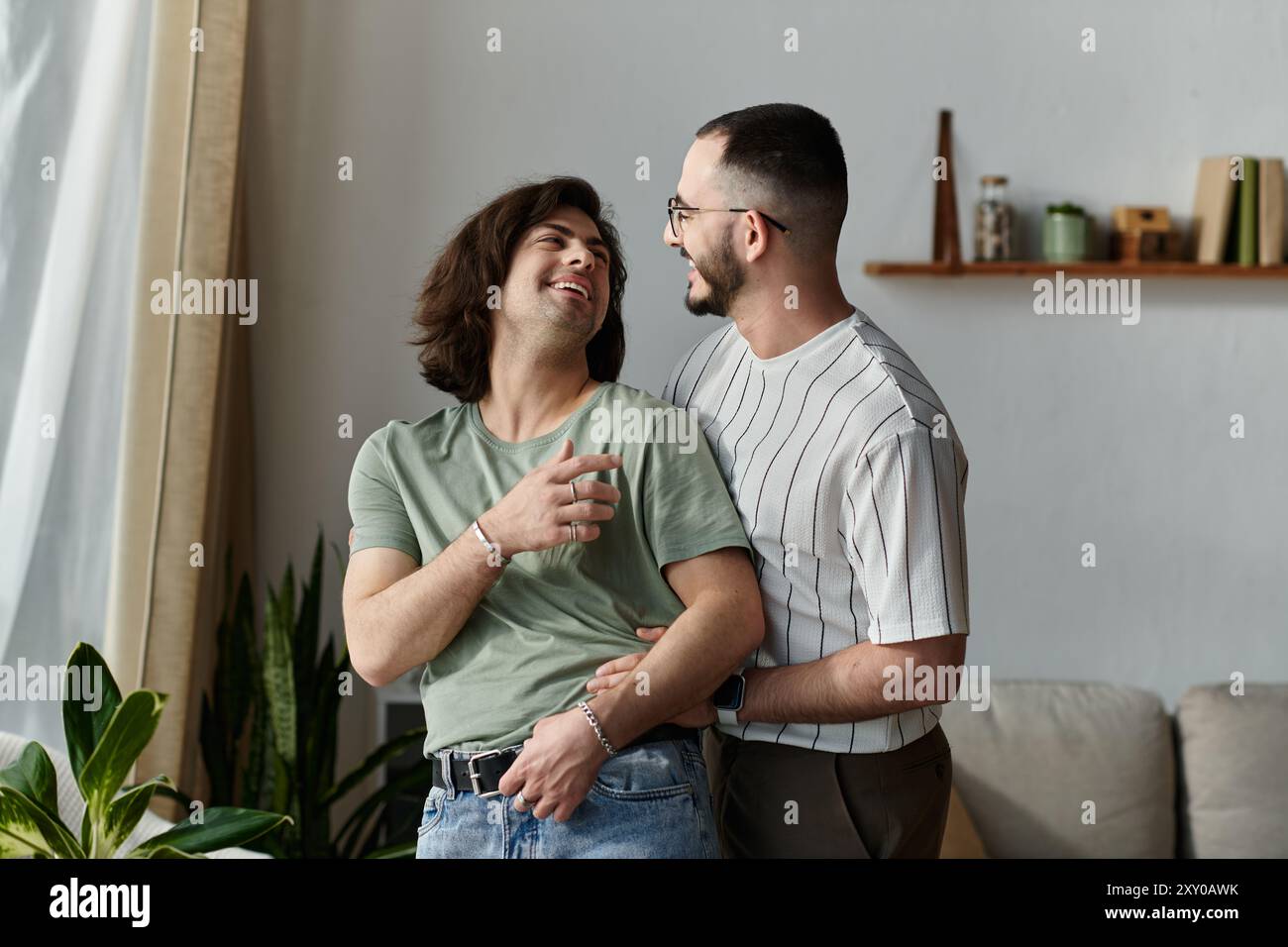 Two men embrace and laugh together in their living room Stock Photo - Alamy
