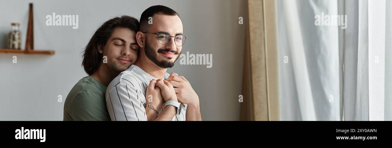 A loving gay couple embraces in a moment of intimacy by a window Stock ...