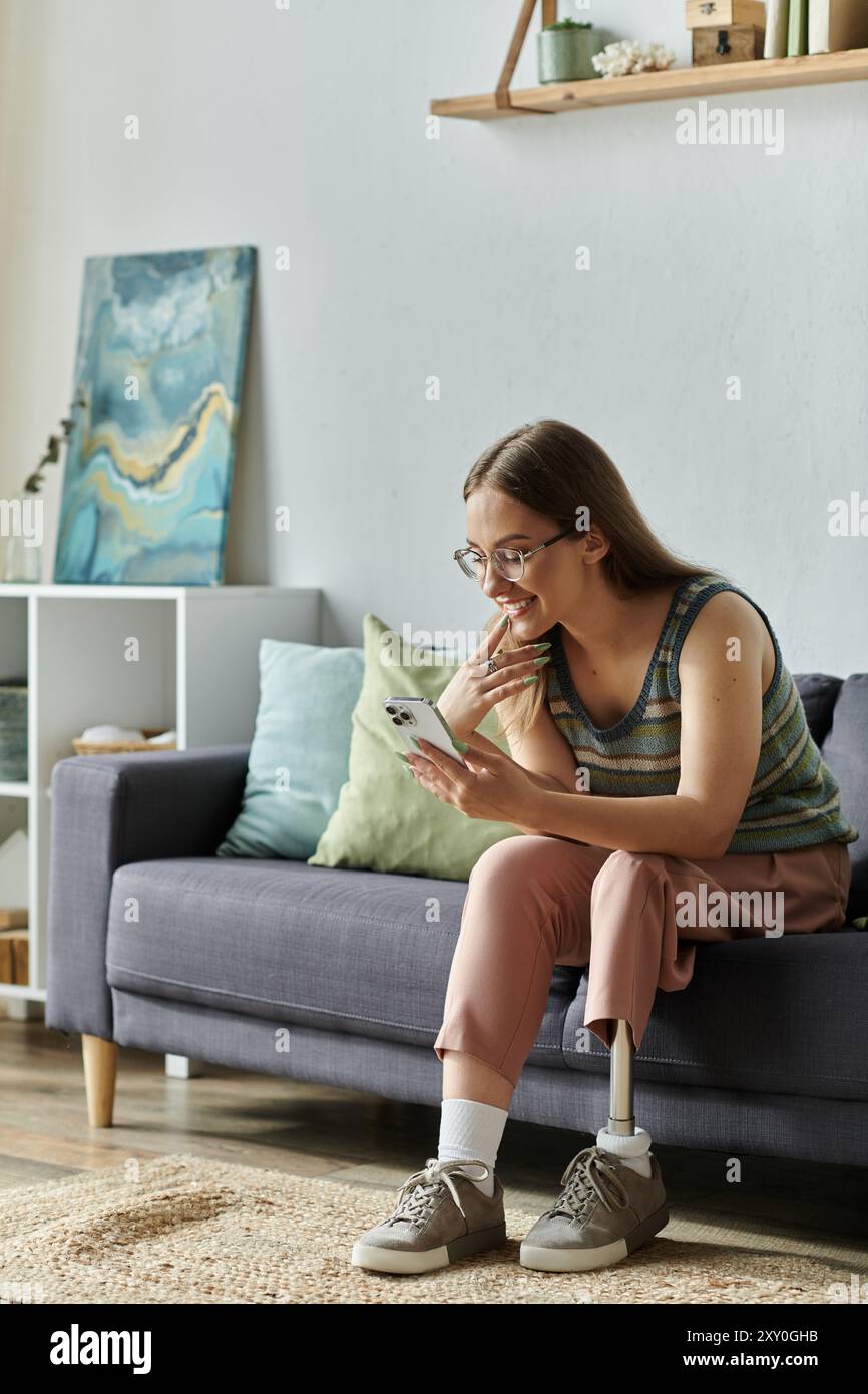A young woman with a prosthetic leg smiles while looking at her phone ...