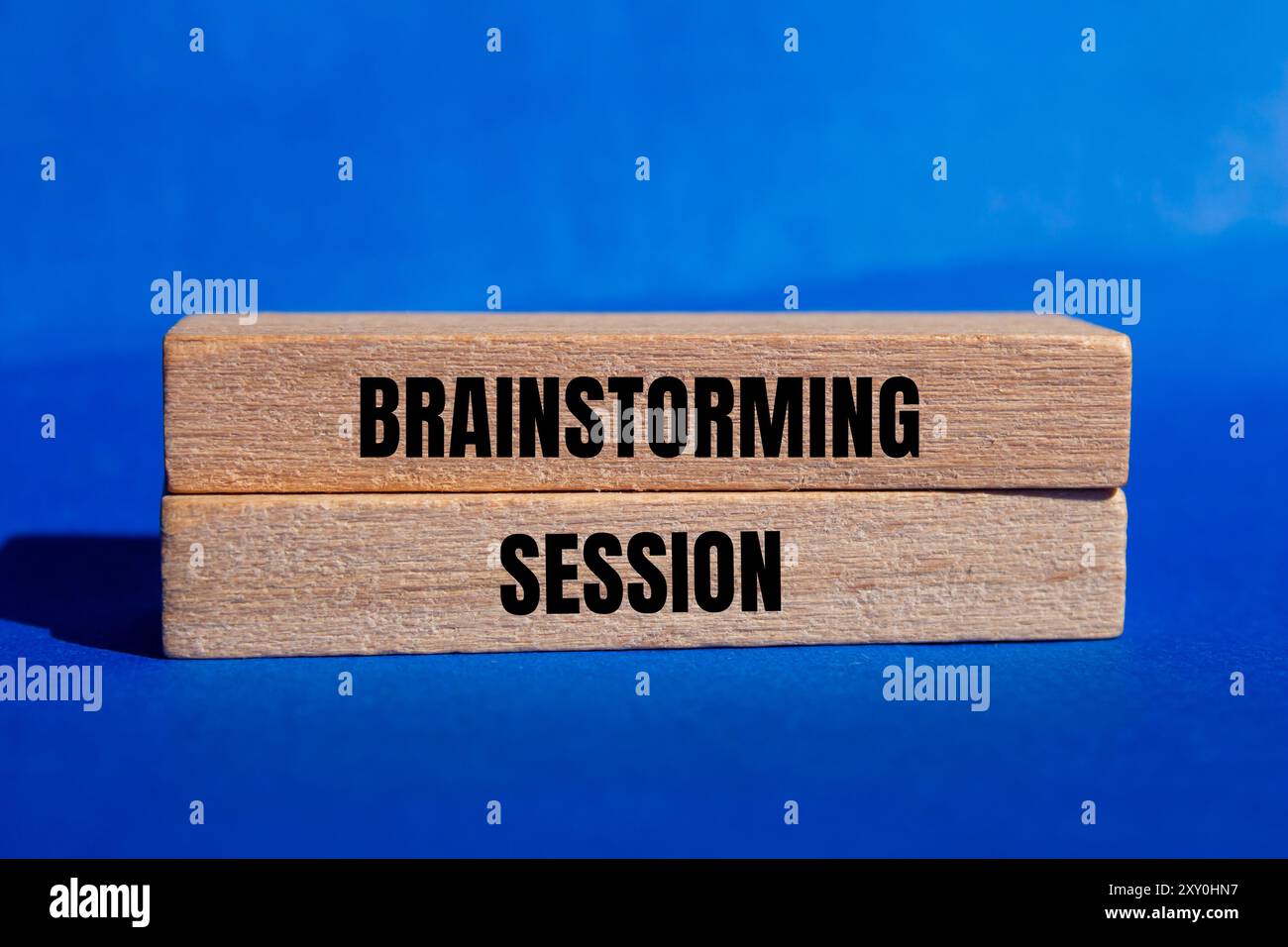 Brainstorming session message written on wooden blocks with blue ...