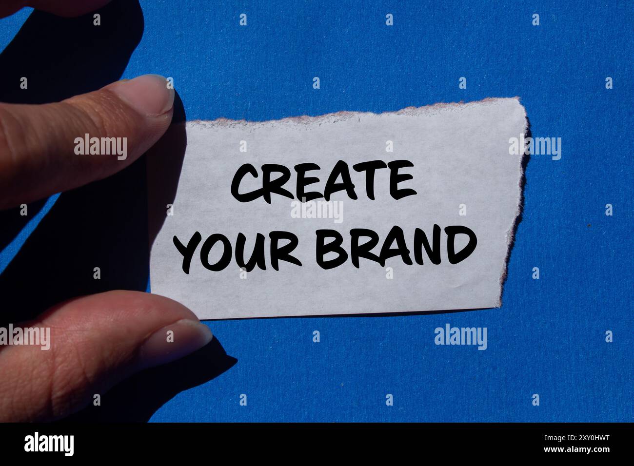 Create your brand message written on ripped torn paper with blue ...