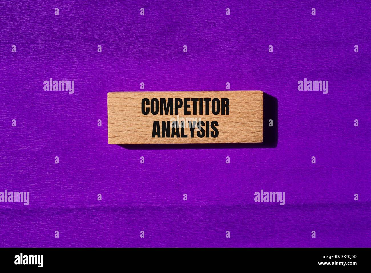 Competitor analysis message written on wooden blocks with purple ...