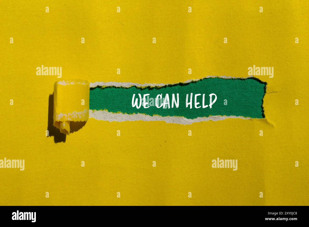 We can help message written on ripped yellow paper with green ...