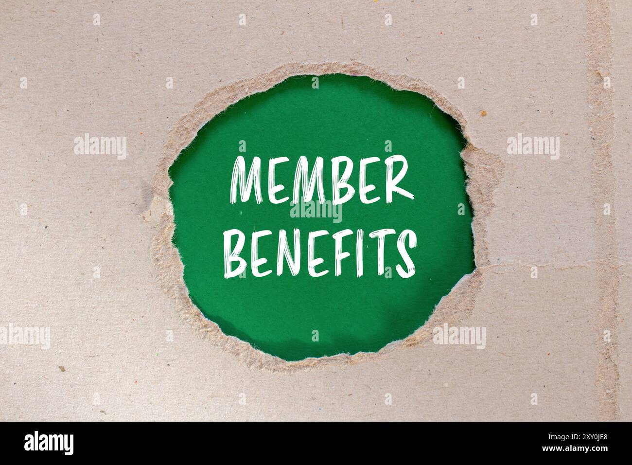 Member benefits message written on ripped torn paper with green background. Conceptual member ...