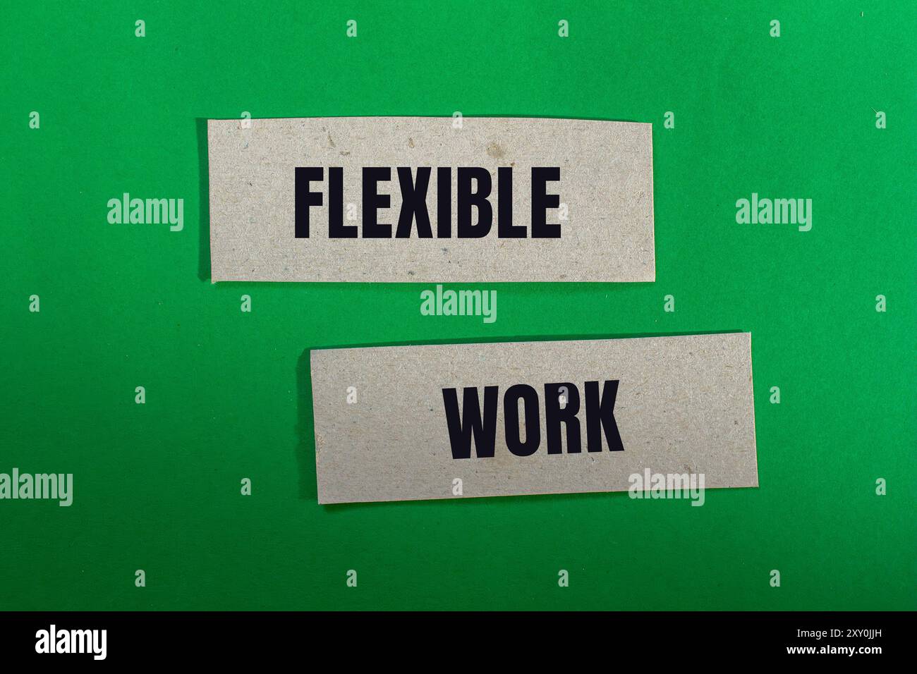 Flexible work message written on paper pieces with green background ...
