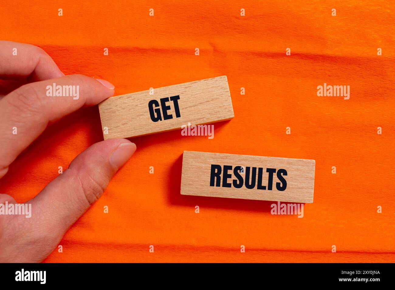 Get results message written on wooden blocks with orange background ...