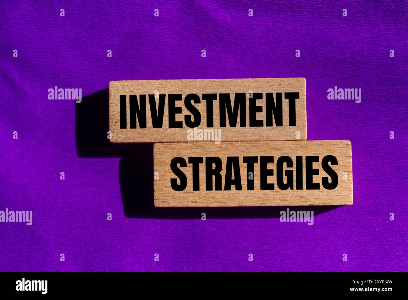 Investment strategies message written on wooden blocks with purple ...