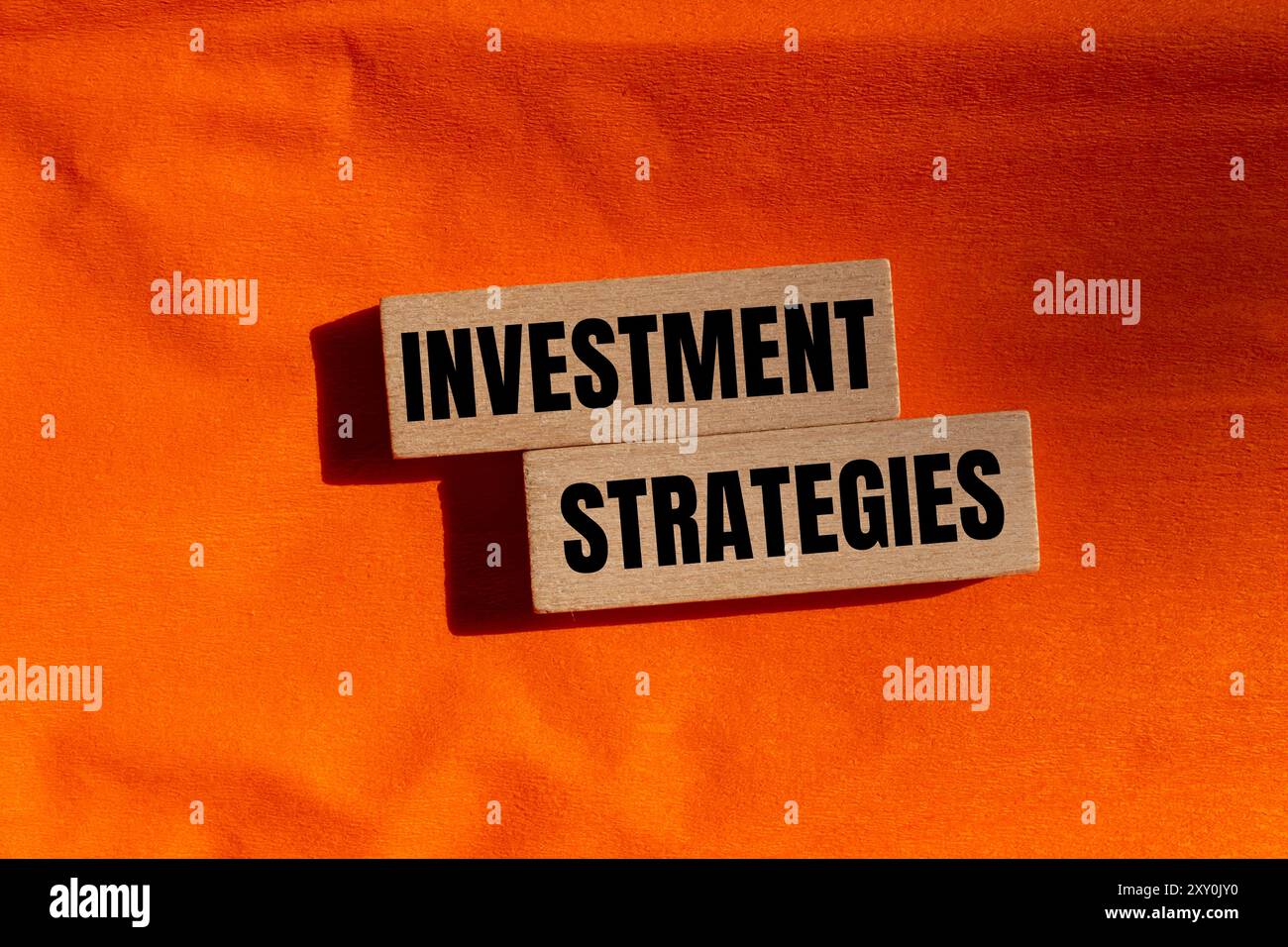 Investment strategies message written on wooden blocks with orange ...