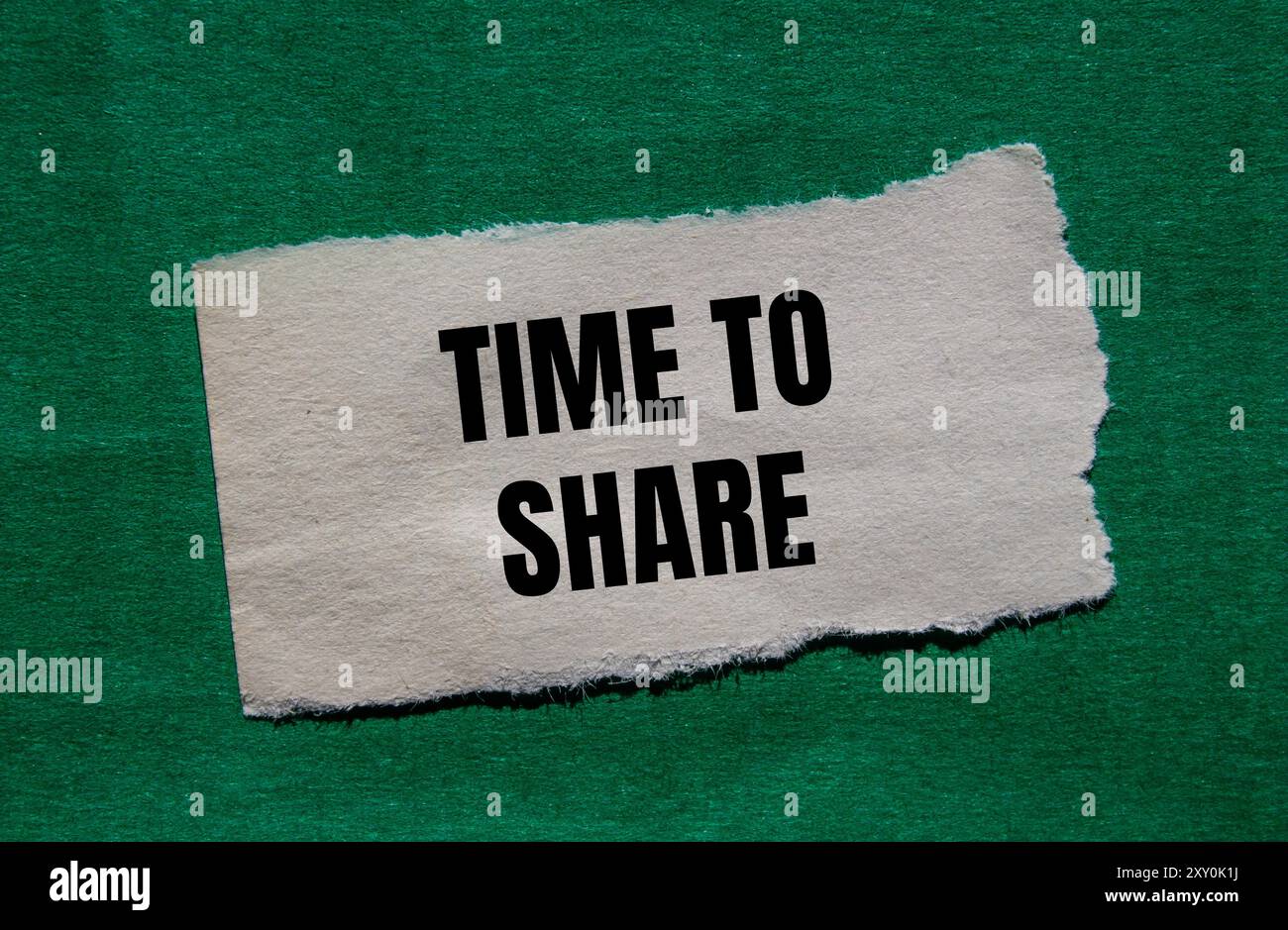 Time to share message written on ripped torn paper piece with green ...