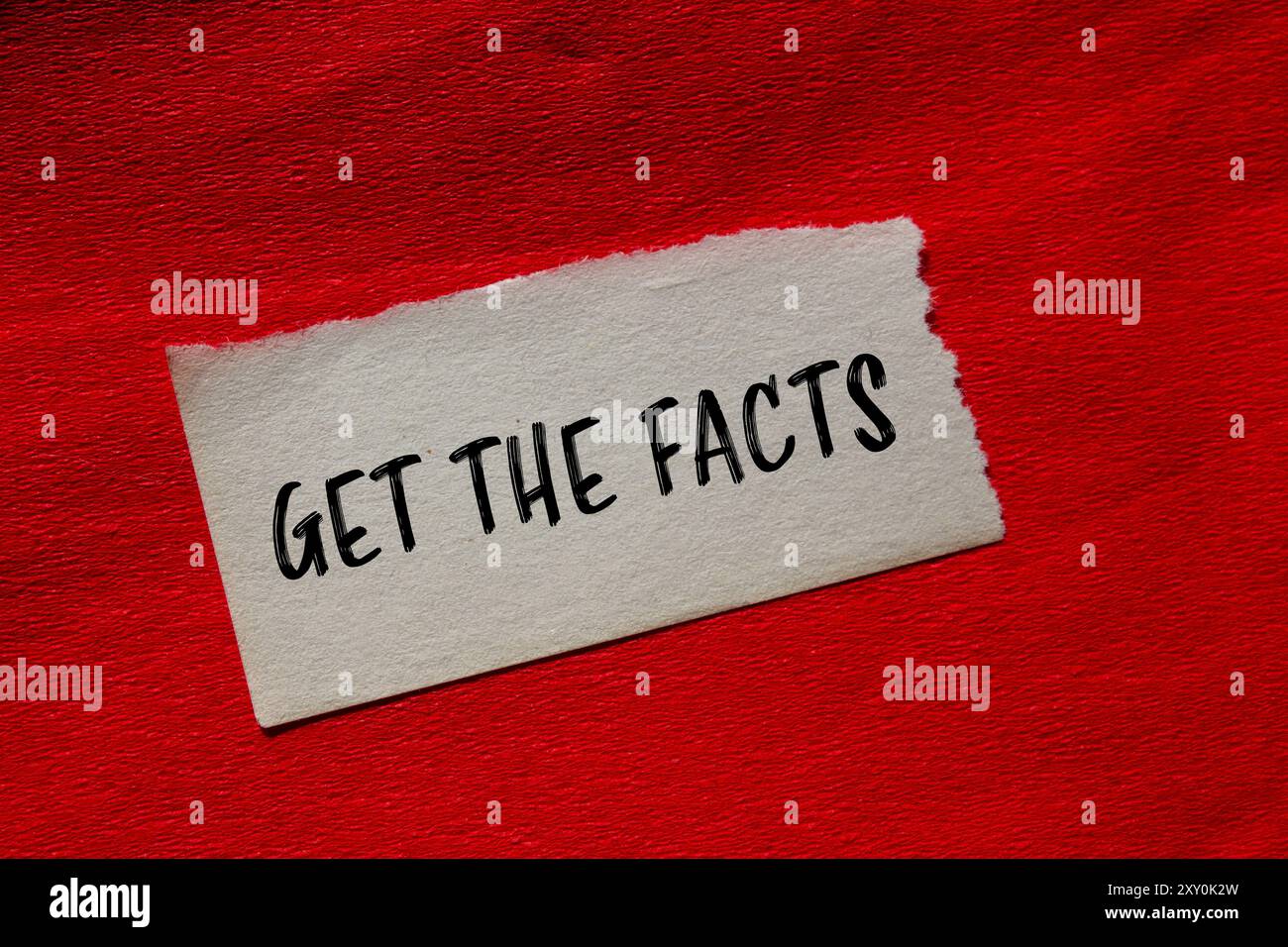 Get the facts message written on ripped torn paper piece with red ...