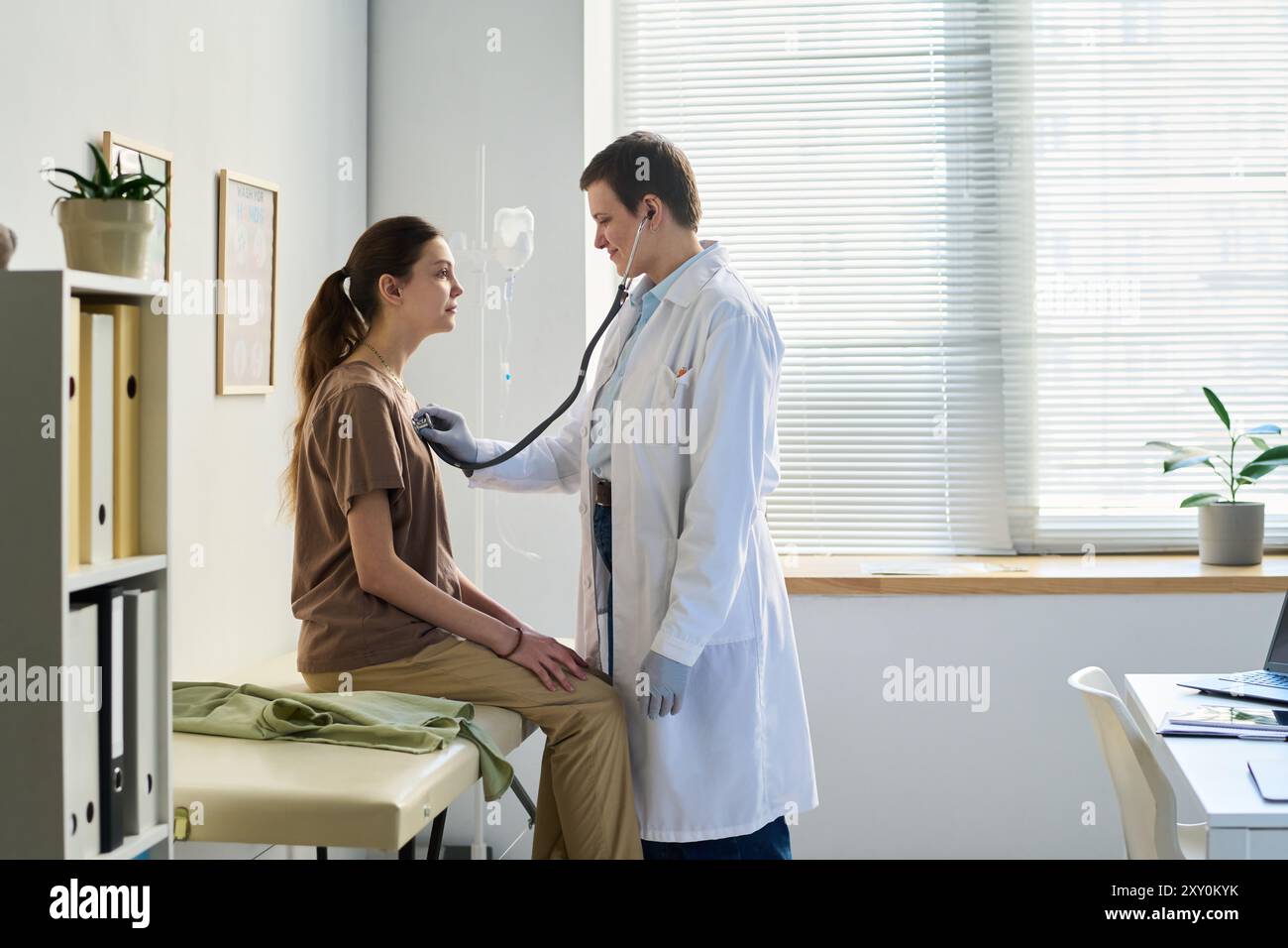 Doctor conducting physical examination using stethoscope on patient ...