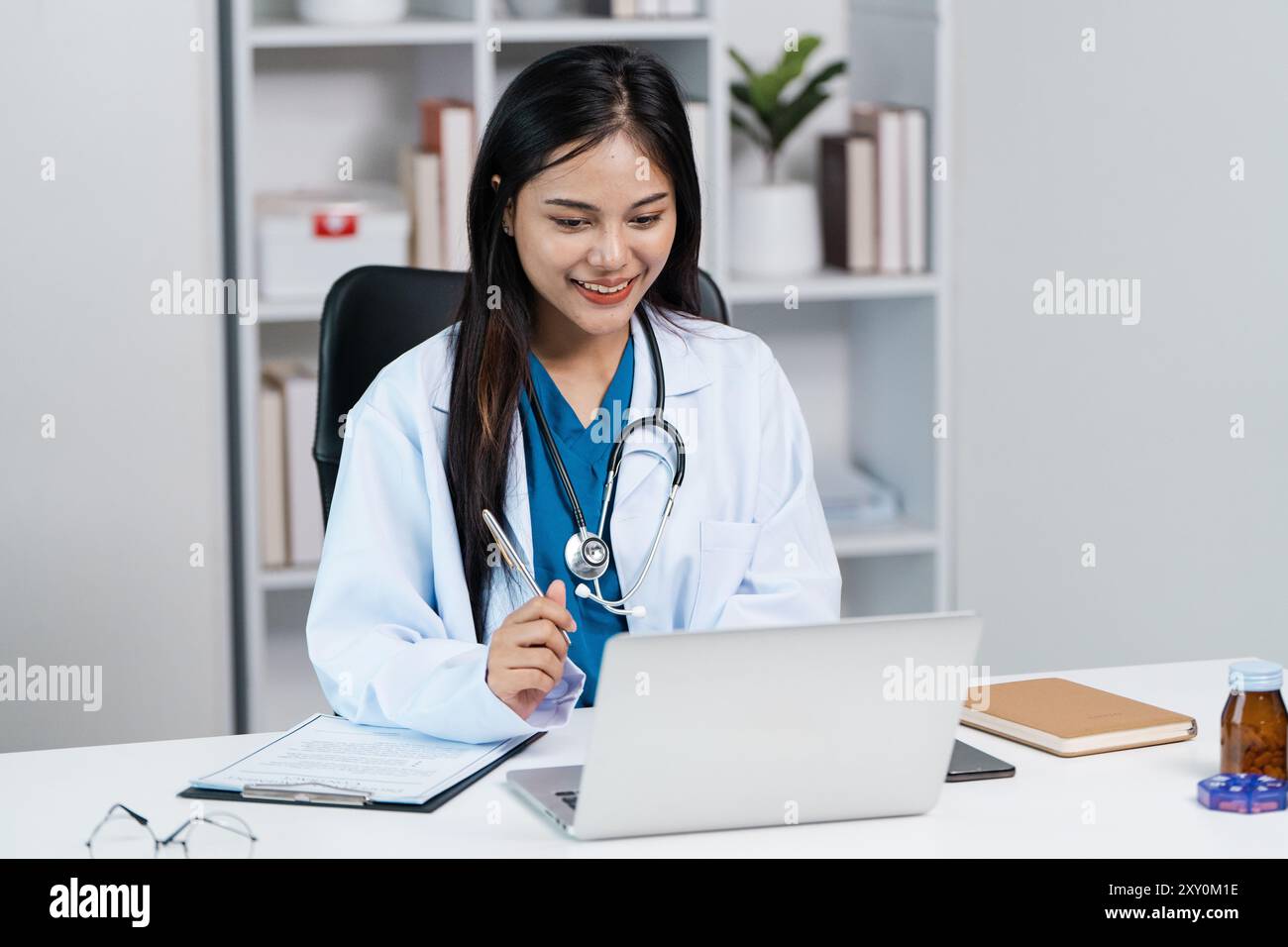 Female Doctor Working on Laptop in Modern Office with Medical Equipment ...