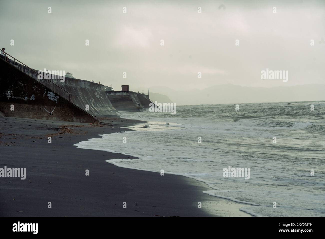 Stormy Seascape - A dramatic coastal scene featuring crashing waves against concrete seawalls ...