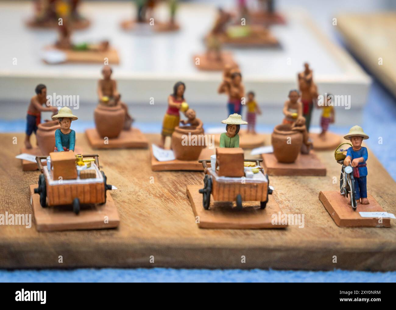 A close-up of artisanal Thai miniatures figurines made of clay, at ...